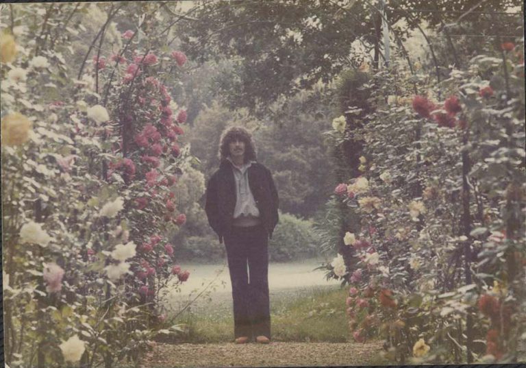 George pictured in a garden on the grounds - The Beatles