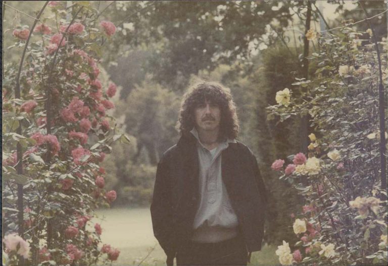 George pictured in a garden on the grounds - The Beatles